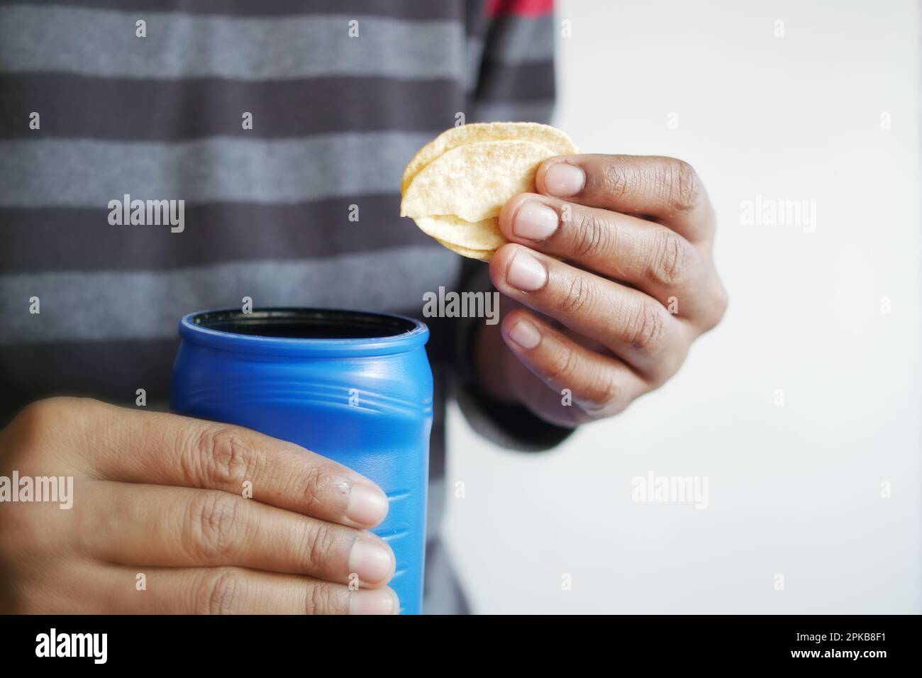 Holding packet of chips hi-res stock photography and images - Alamy