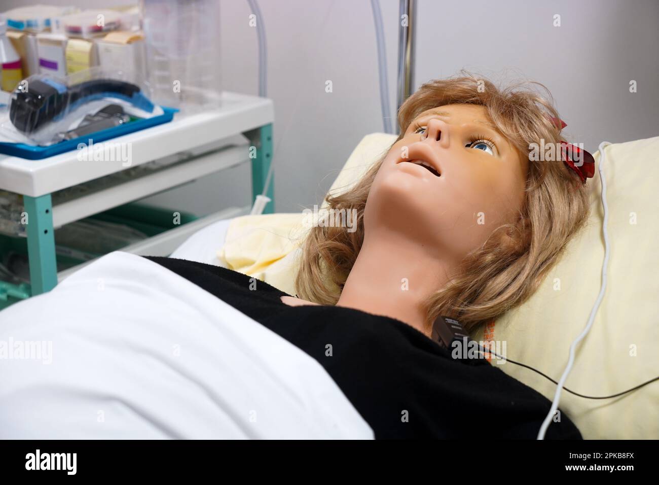 Students facing a post natal emergency follow procedures on a mannequin ...