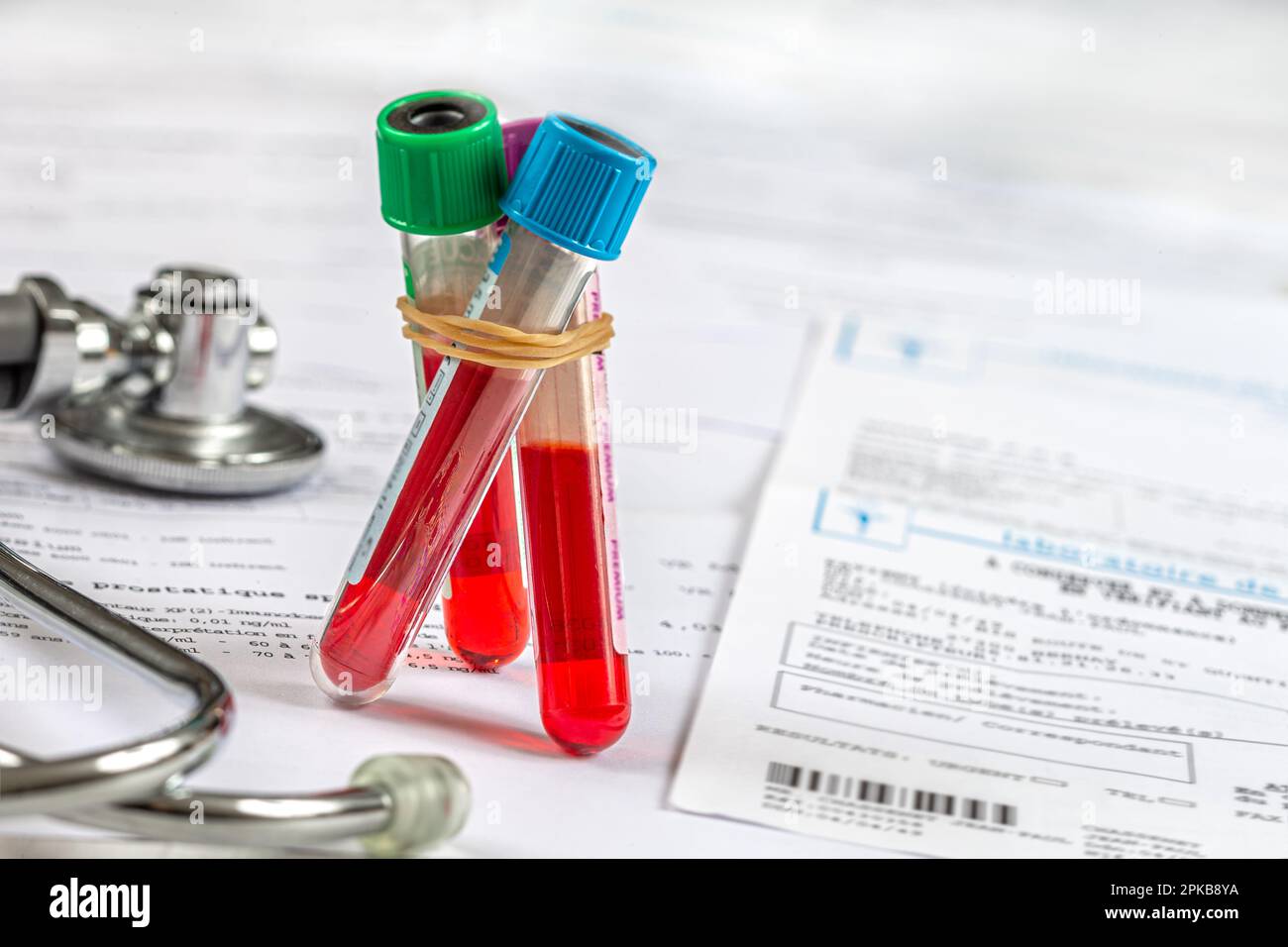 Blood tubes and stetoscope placed on test results Stock Photo - Alamy
