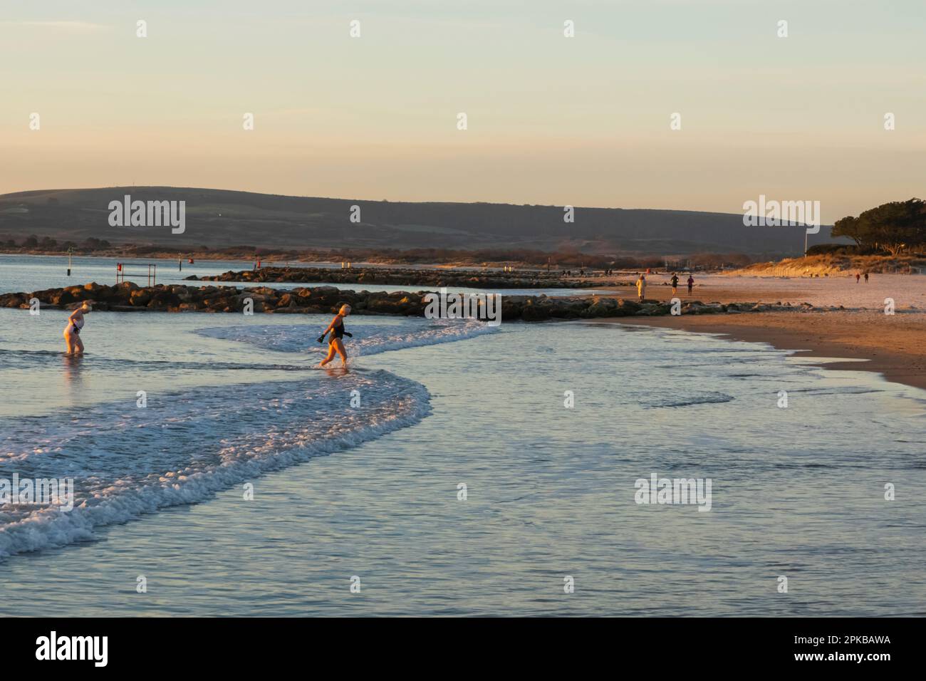 England, Dorset, Poole, Sandbanks Beach, Two Female Swimmers in The Sea ...