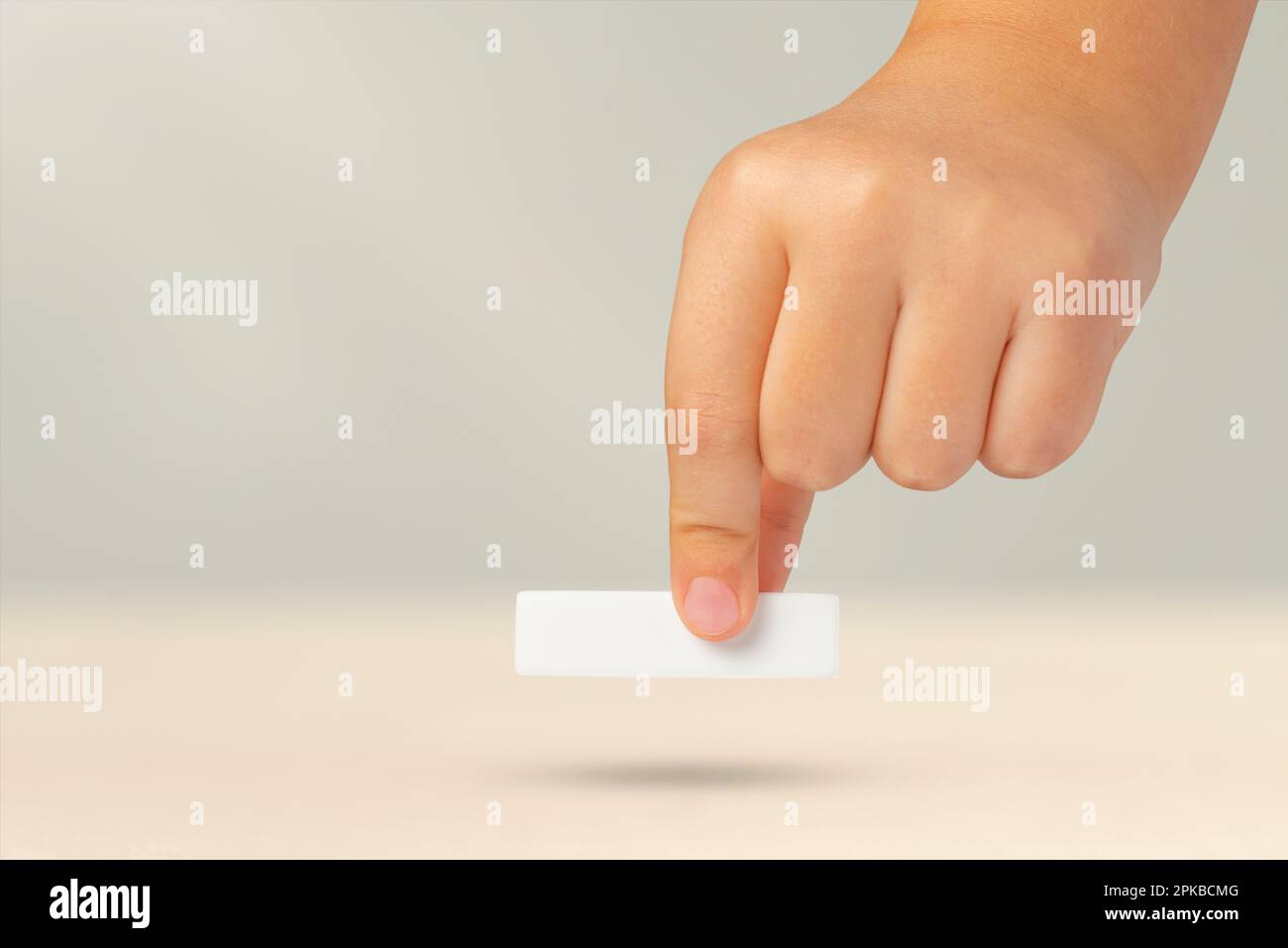 Minus sign in hand. White minus sign in a child's hand on a gray ...