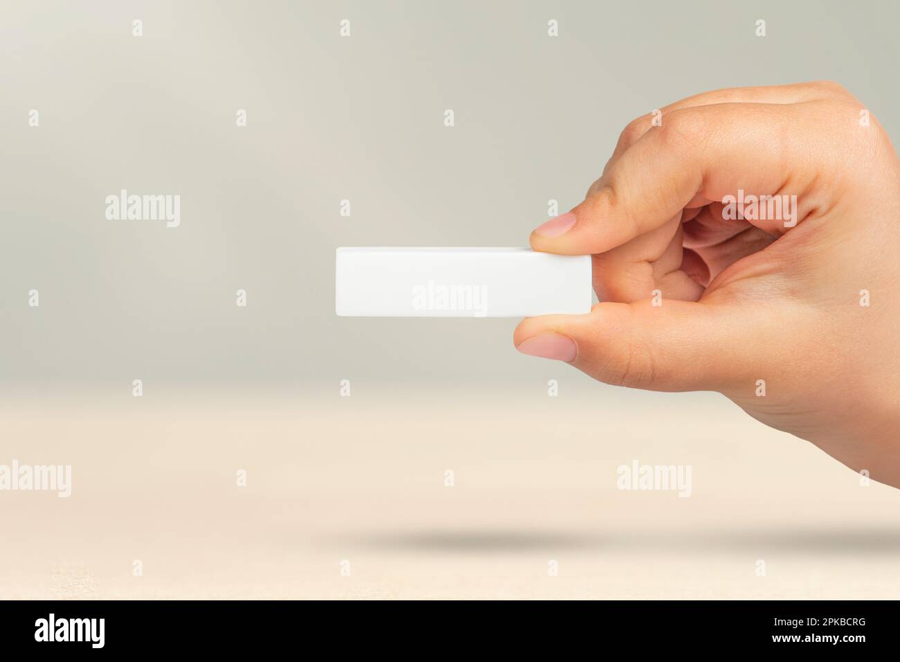 Minus sign in hand. White minus sign in a child's hand on a gray ...