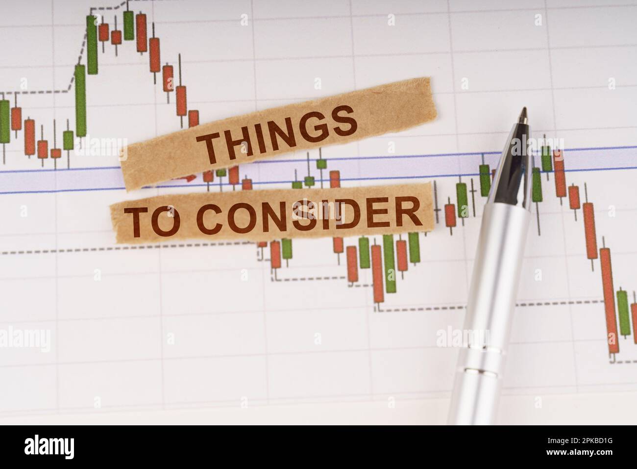 Business concept. On the chart of business quotes lies a pen and torn ...