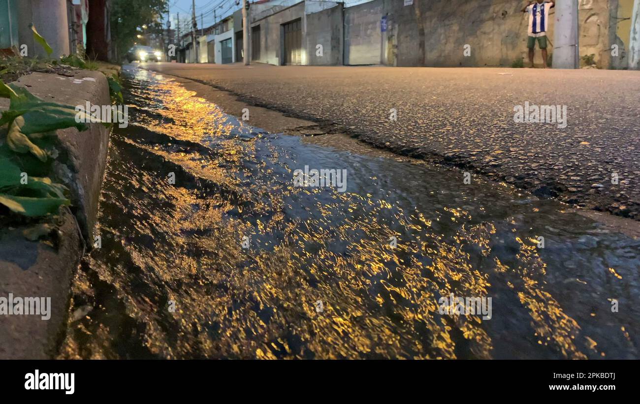 Water sewage flowing in street after rain Stock Photo - Alamy