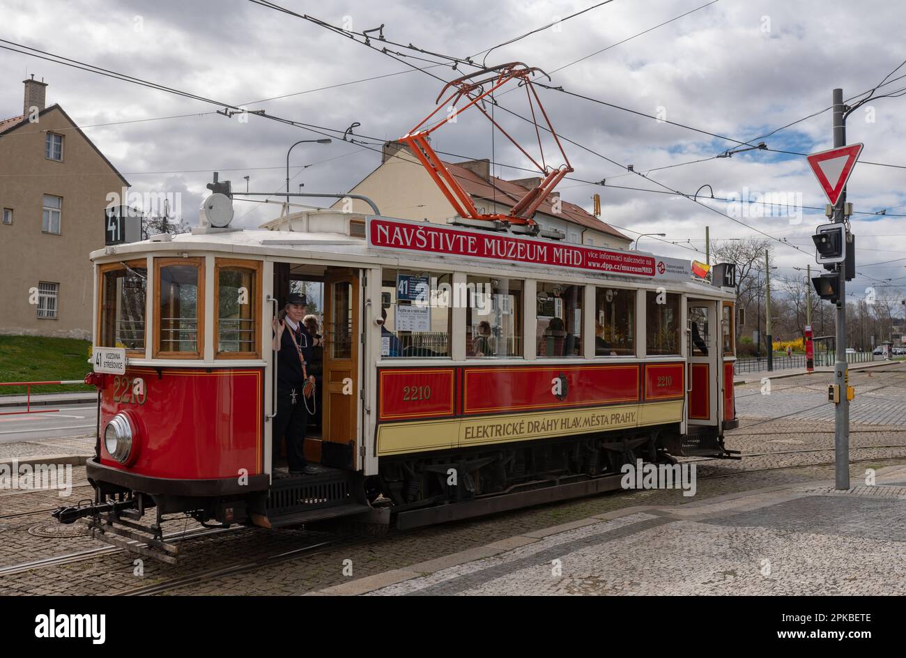 A conductress standing in a door of a historic sightseeing tram in ...