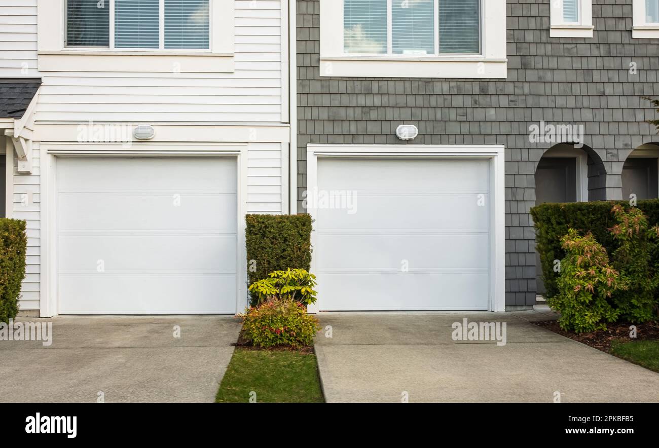 Double garage with short driveway in a sunny day. Wide Garage Door with ...