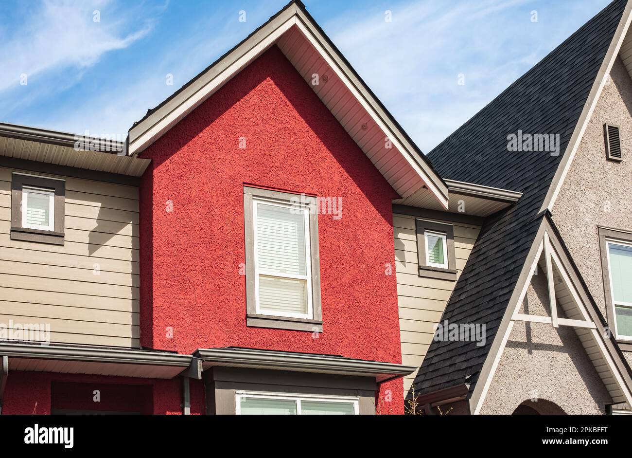 Top of a house with nice windows in the blue sky background. Beautiful ...