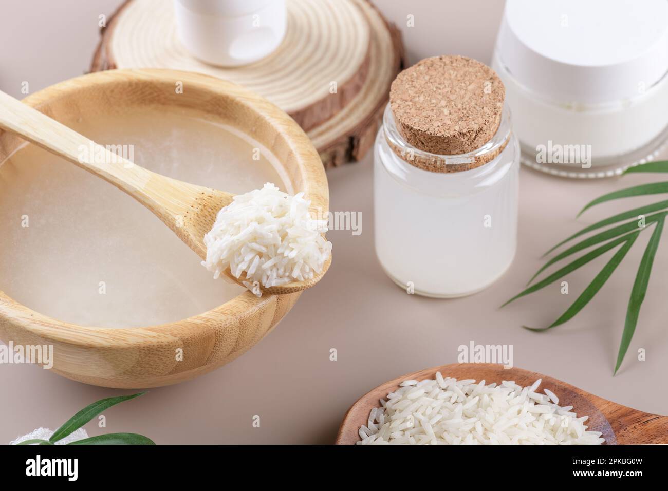 Homemade cosmetic rice water with ingredients and beauty kit on beige ...