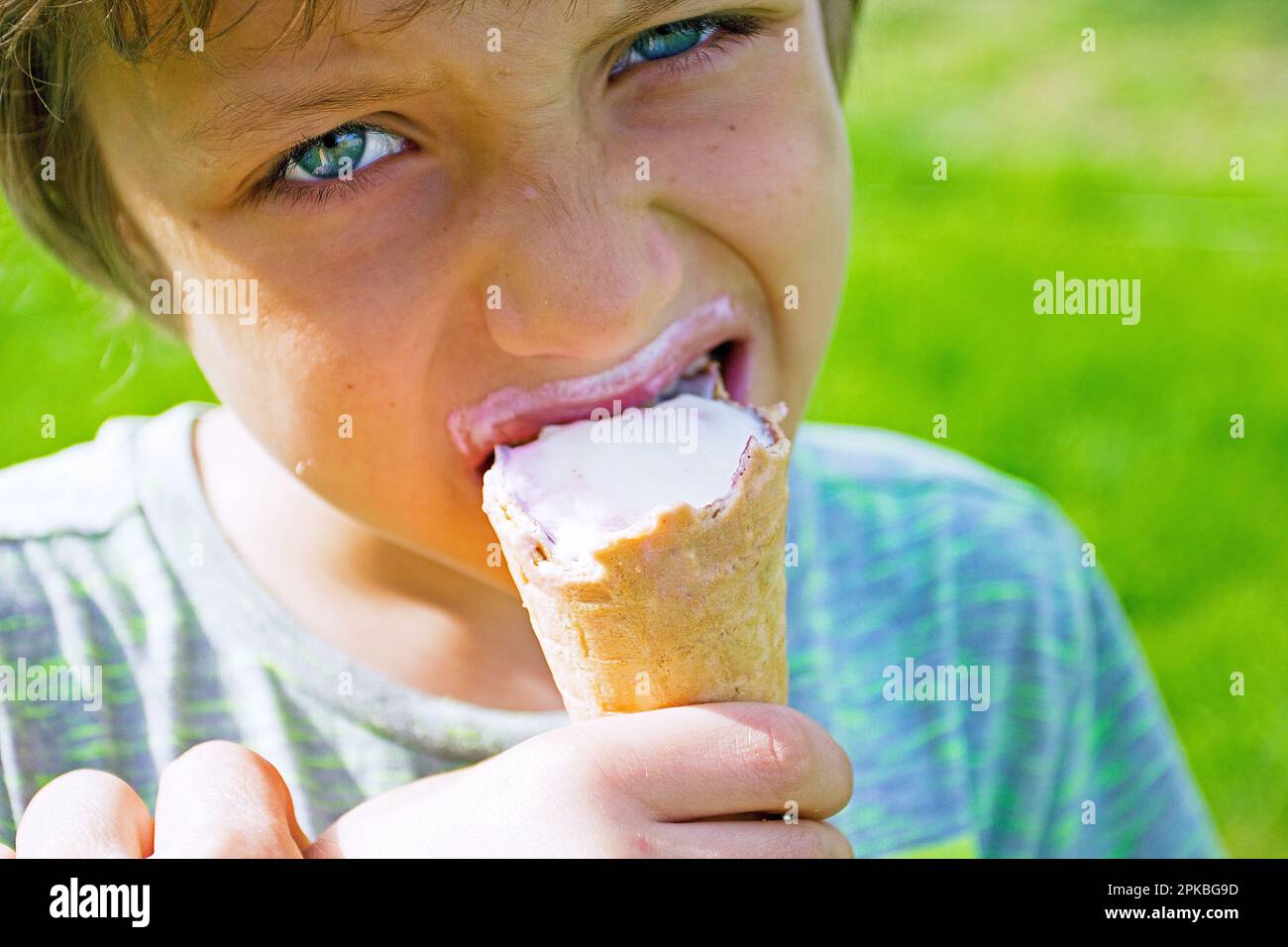 boy eating ice cream in a waffle cup in nature Stock Photo - Alamy