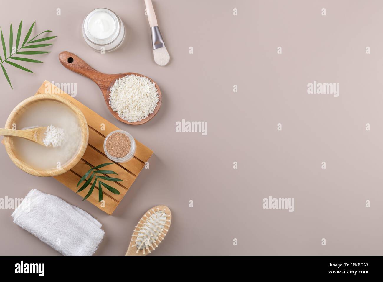 Homemade cosmetic rice water with ingredients on beige background ...