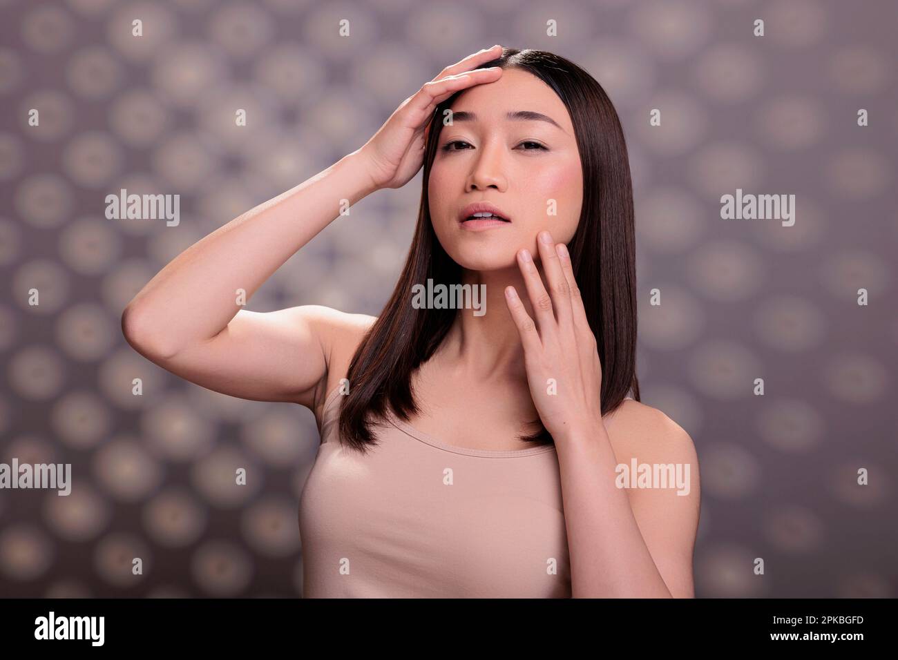 Asian beautiful fashion model posing with hands on face. Attractive ...