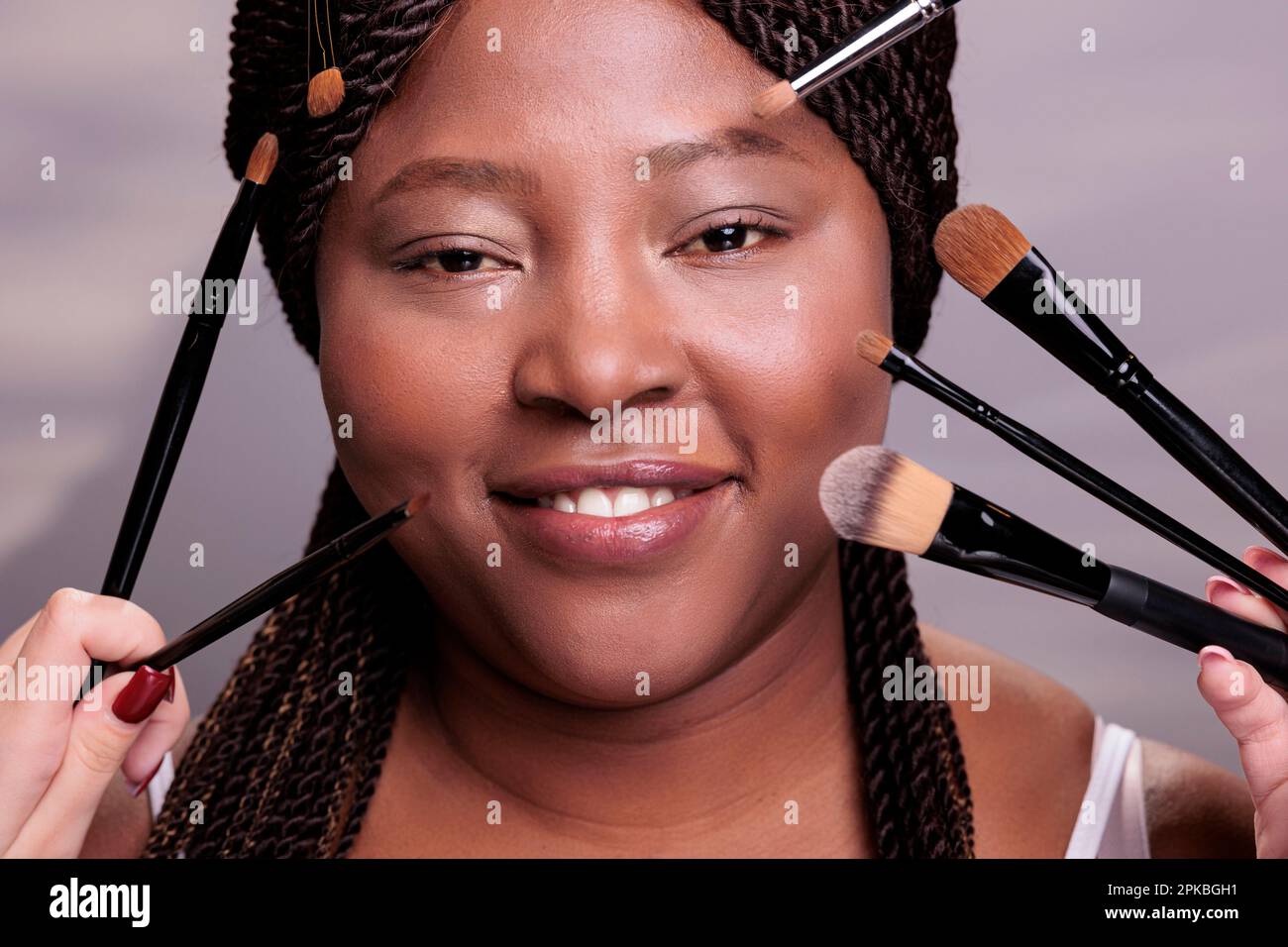 African american woman getting professional make up portrait. Makeup ...
