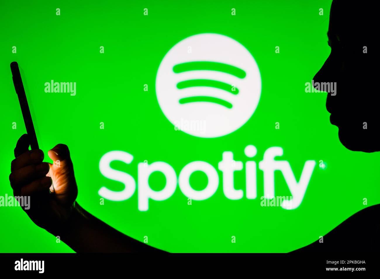 In this photo illustration, a woman's silhouette holds a smartphone ...