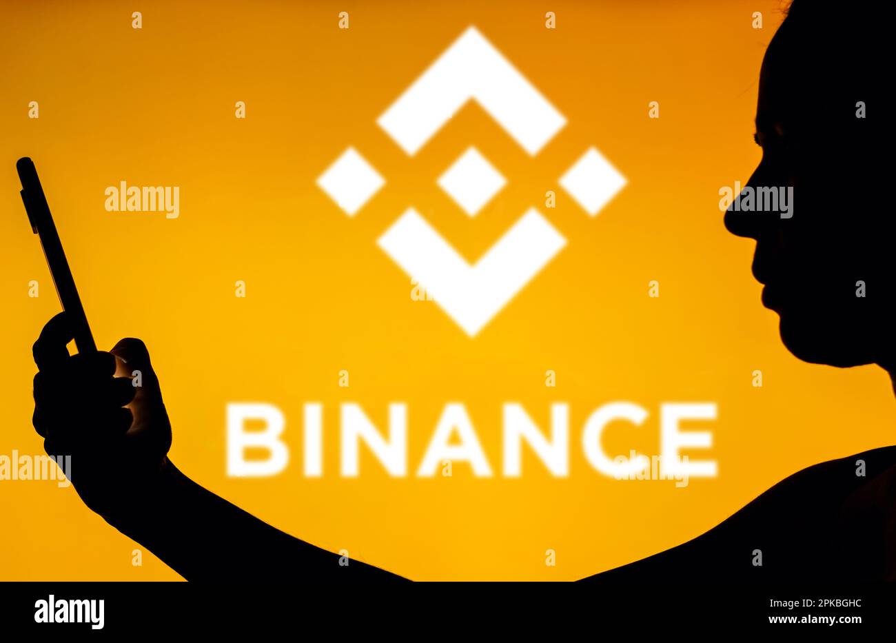 In this photo illustration, a woman's silhouette holds a smartphone ...