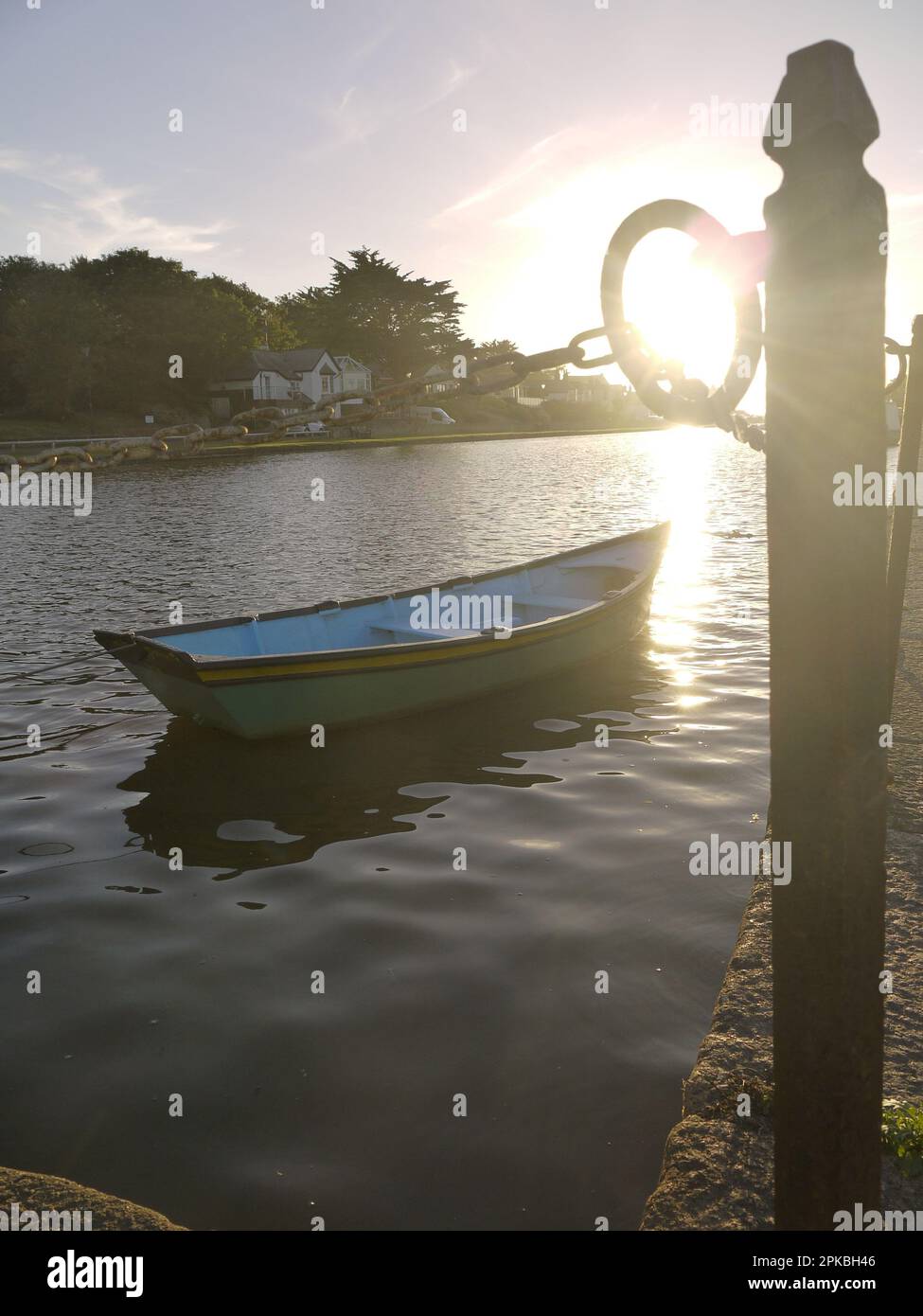 Vertical shot of sunset through a chain link fence by Bude Canal, Bude ...