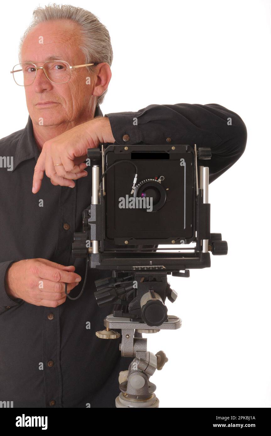 Senior photographer with a large format camera on tripod Stock Photo ...