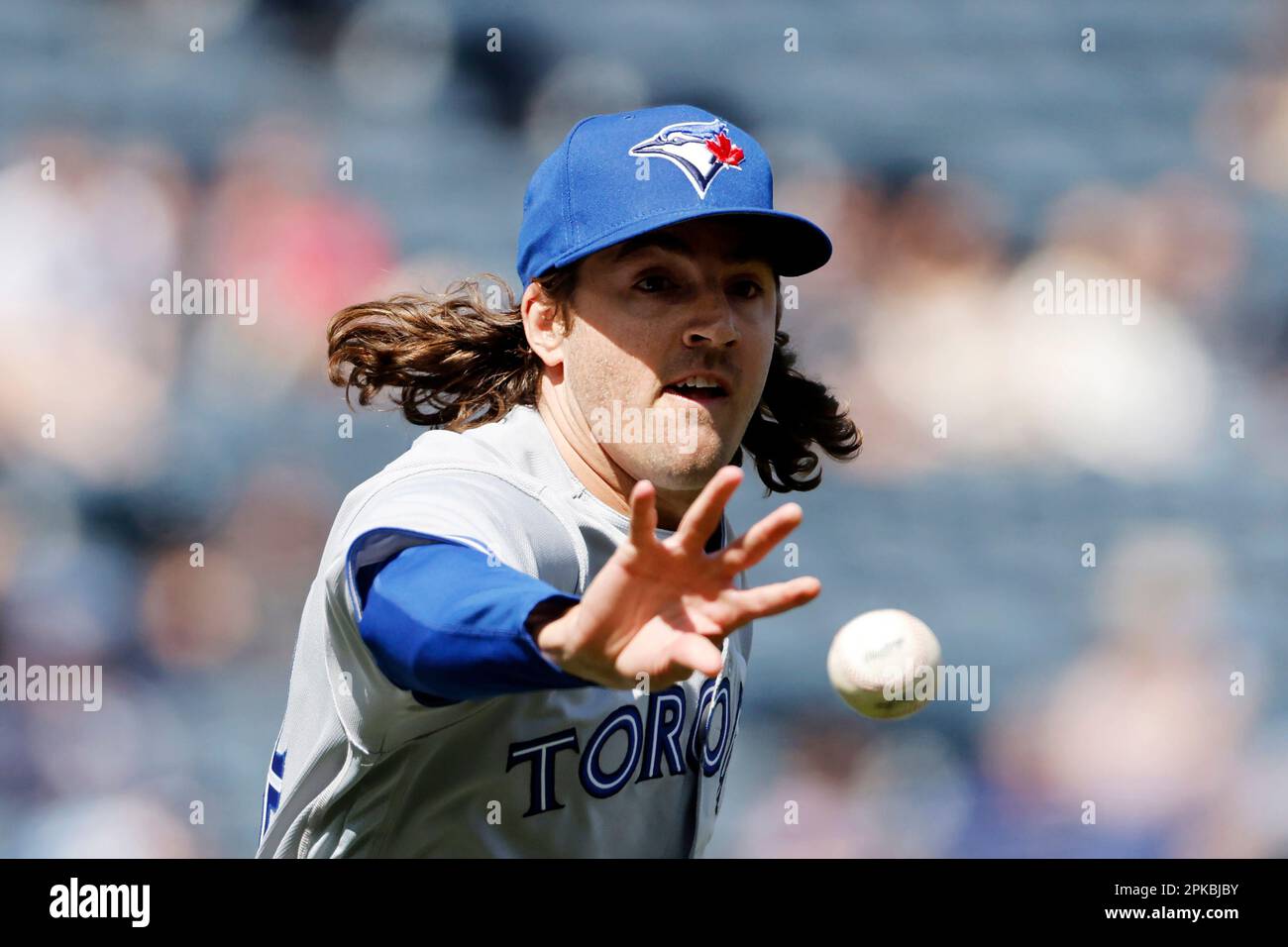 Toronto Blue Jays pitcher Kevin Gausman tosses the ball to first base ...