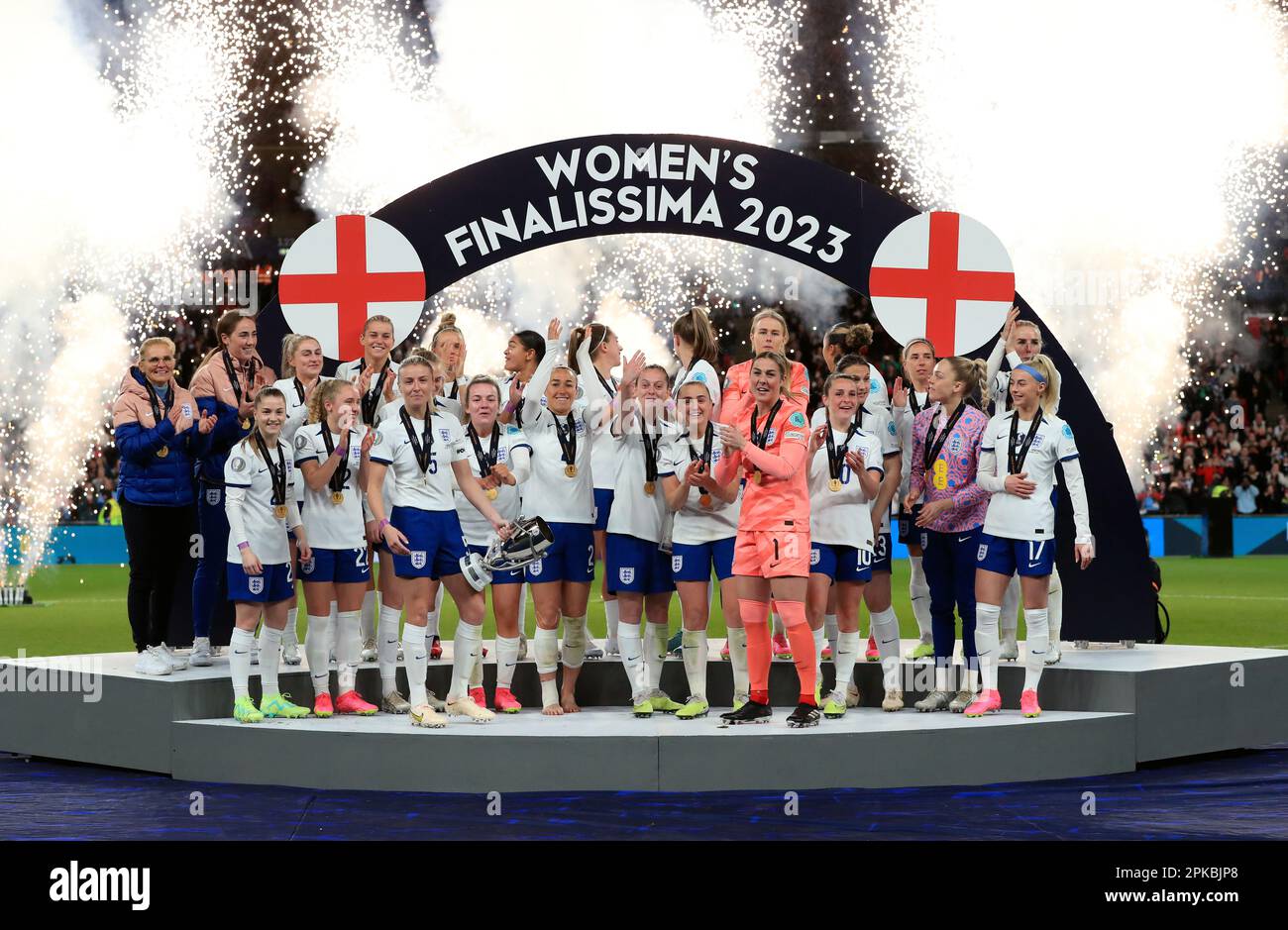 England players on the podium lift the trophy following the Women's ...