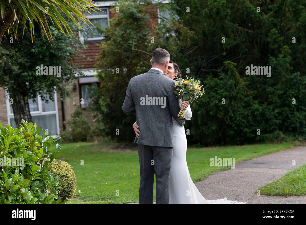 Wedding day couple holding each other embracing, love Stock Photo - Alamy