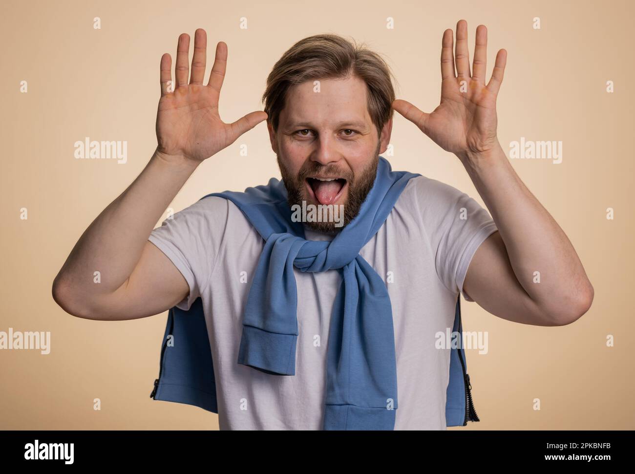 Comical funny young caucasian man making playful silly facial ...