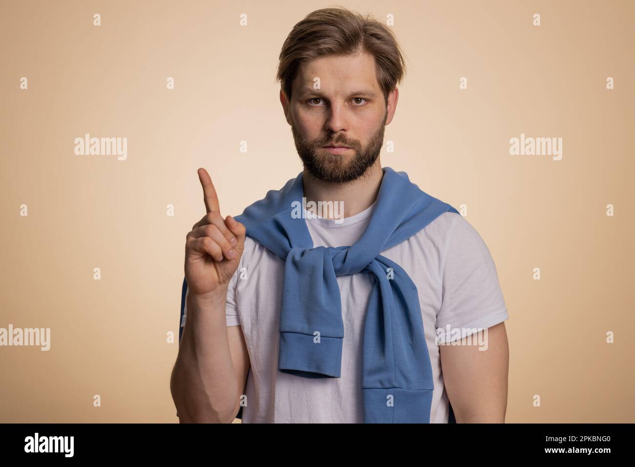 Caucasian handsome man shakes finger and saying No, be careful ...