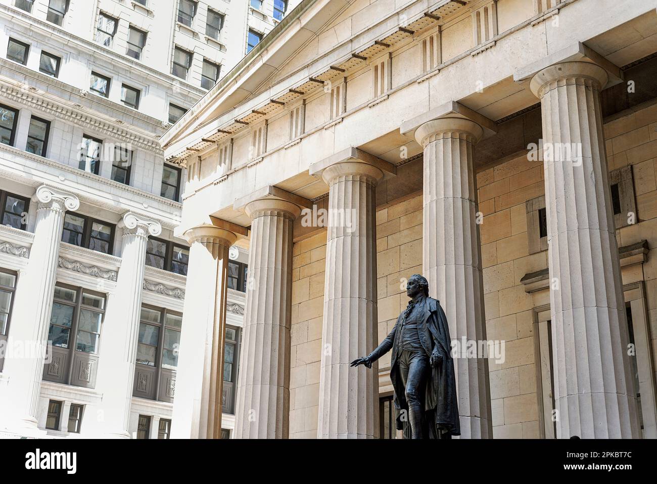 A bronze statue of George Washington in front of the Federal Hall ...