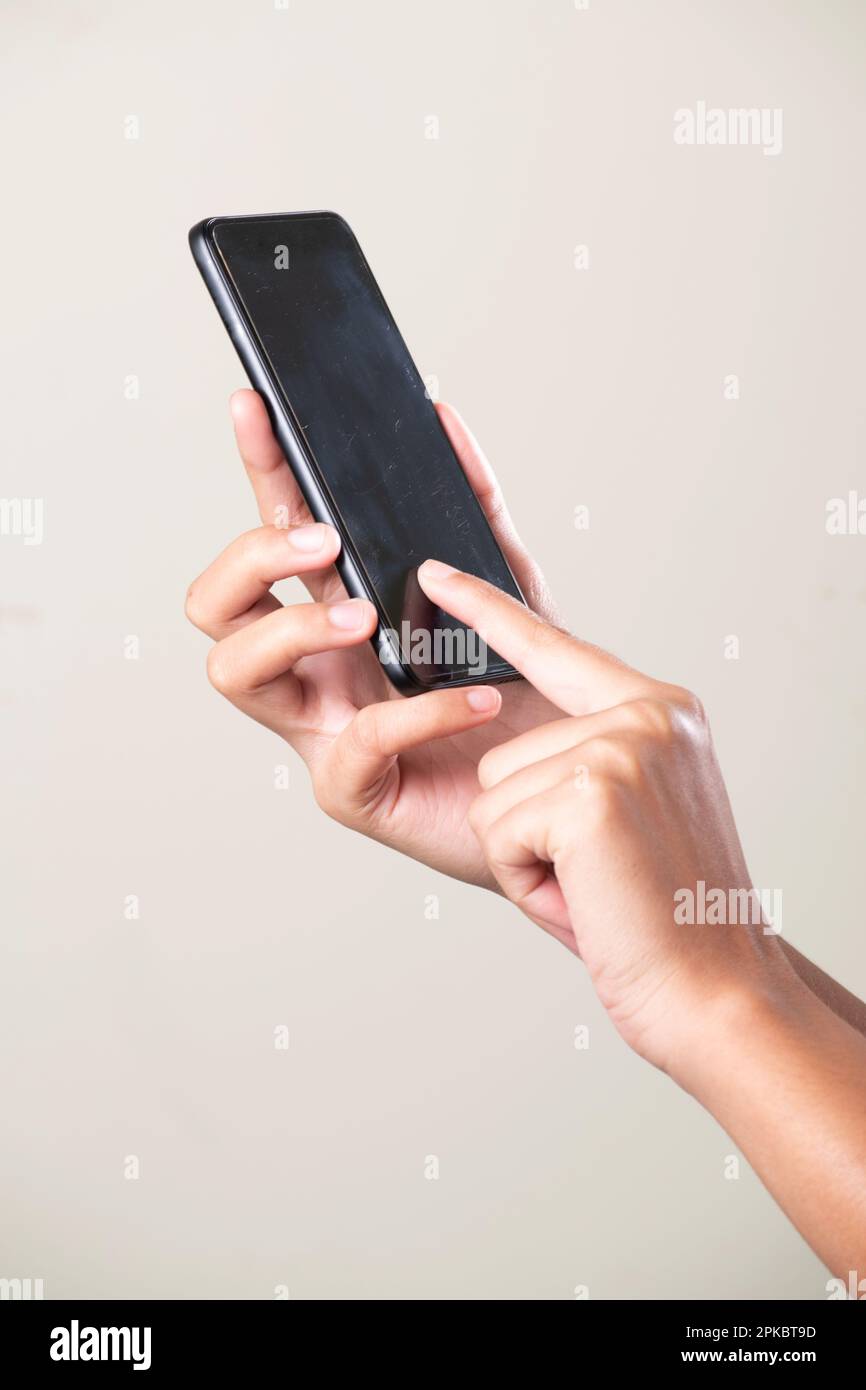 Using smartphone finger touch on grey background Stock Photo - Alamy