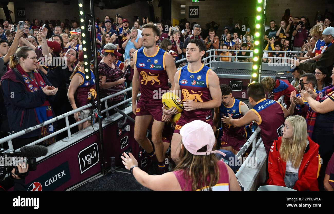 Harris Andrews and Lachie Neale of the Lions lead their team out during ...