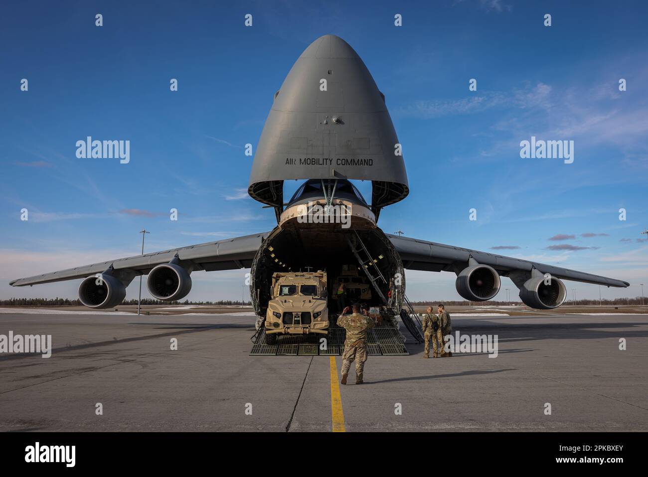 A U.S. Airman ground guides U.S. Marines with 1st Battalion, 10th ...