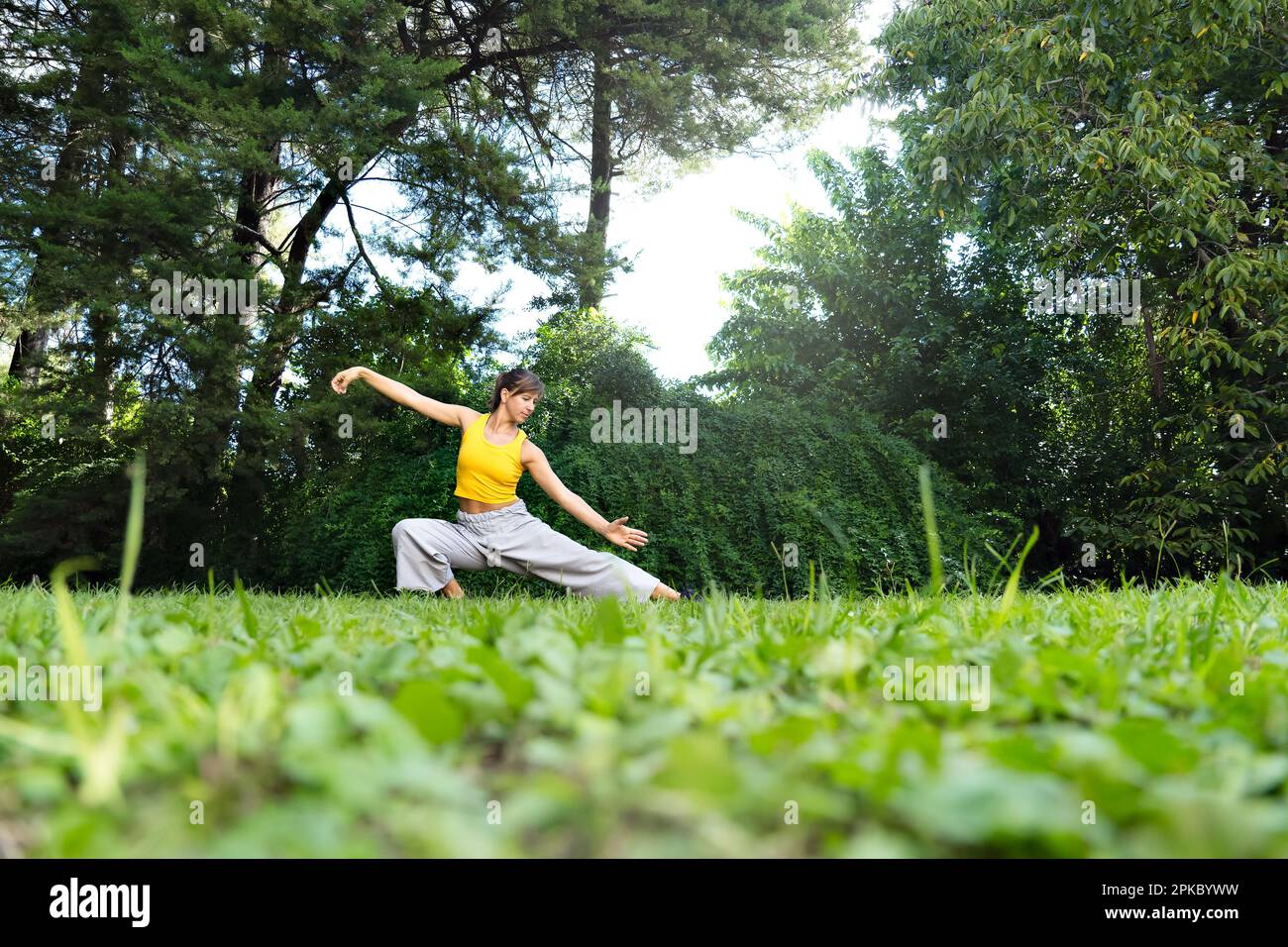 Woman practicing tai chi chuan outdoors. Practicing Tai Chi can help ...