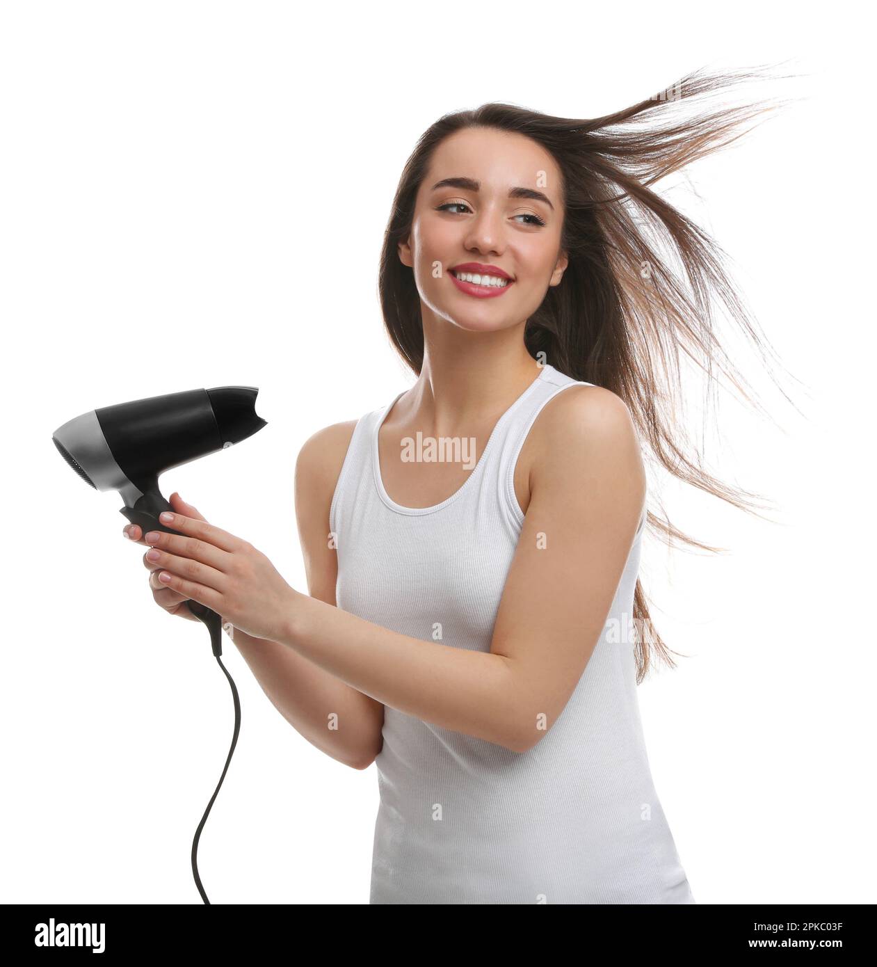 Beautiful young woman using hair dryer on white background Stock Photo ...