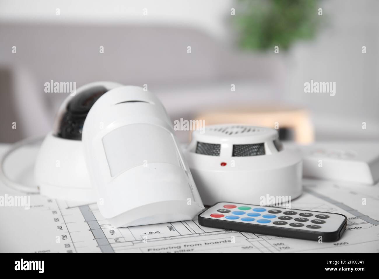 CCTV camera, remote control, smoke and movement detectors on building ...