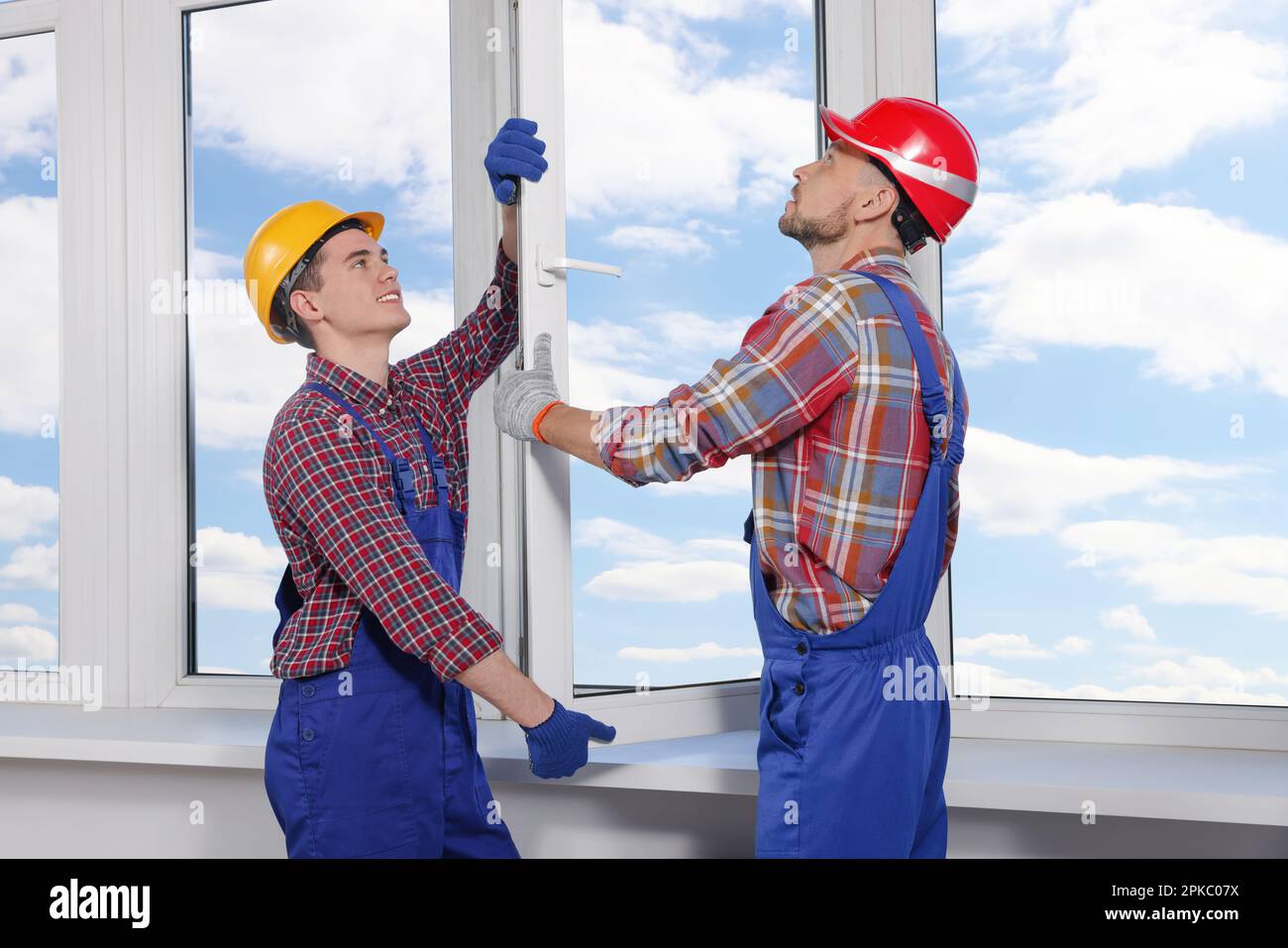 Young workers installing new hi-res stock photography and images - Alamy