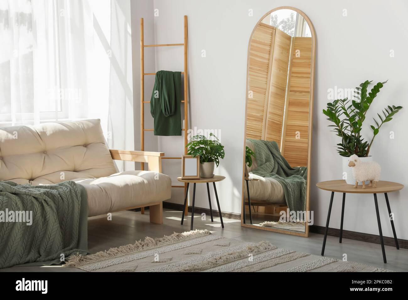 Stylish room interior with leaning floor mirror Stock Photo - Alamy