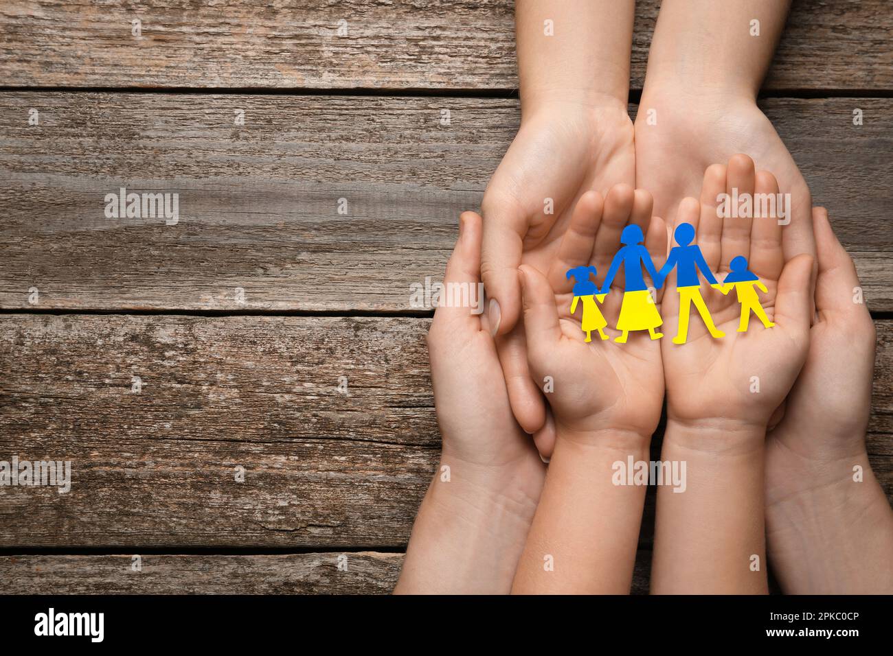 Parents and child holding paper family cutout in colors of Ukrainian ...