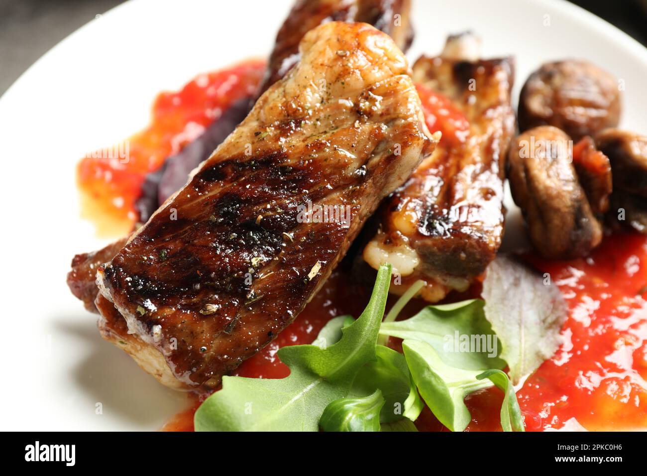 Delicious grilled ribs in plate, closeup view Stock Photo - Alamy