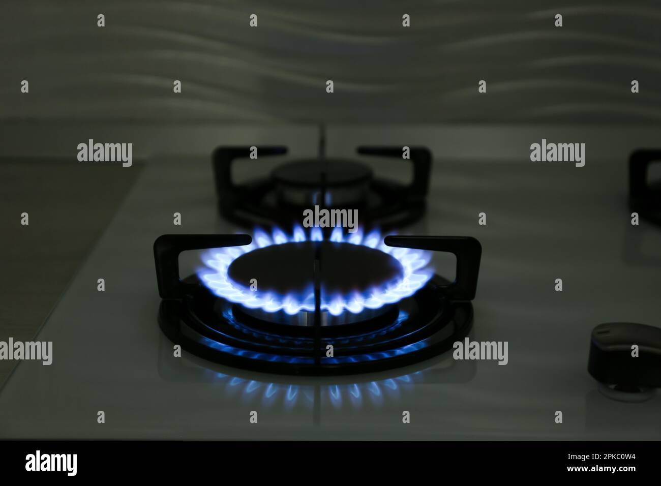 Modern gas cooktop with burning blue flame in kitchen at night Stock ...