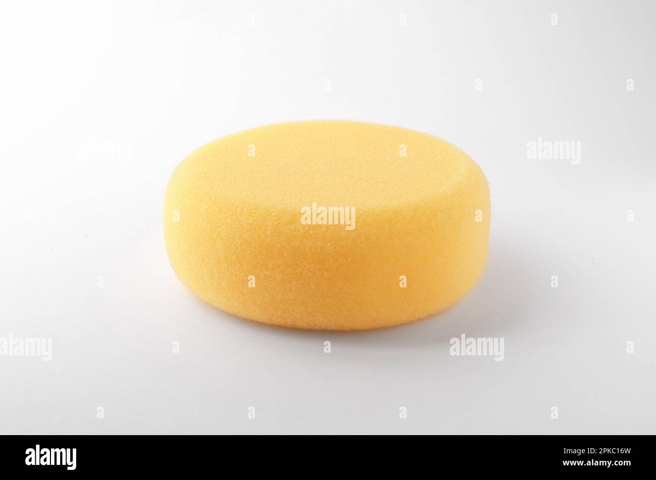 Yellow sponge for clay modeling on white background Stock Photo - Alamy
