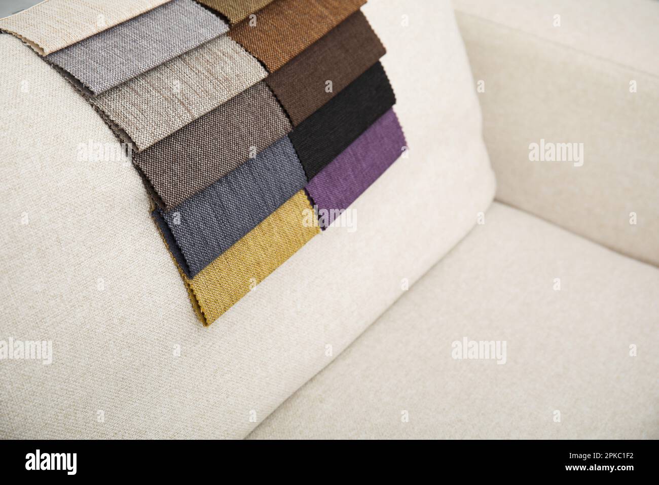 Catalog of colorful fabric samples on beige sofa Stock Photo - Alamy