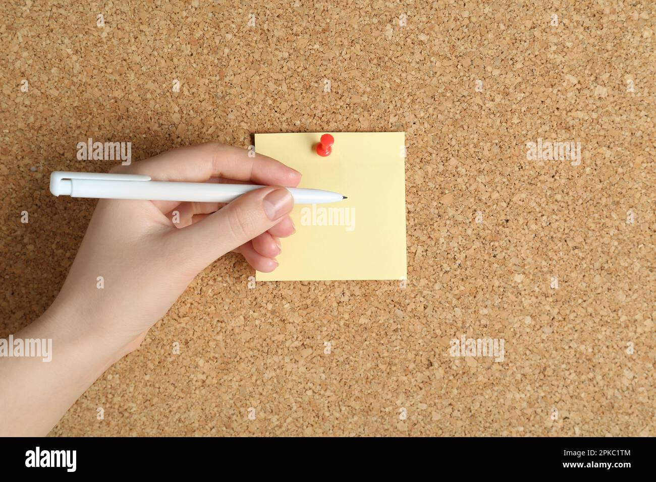 Woman writing on post it note hi-res stock photography and images - Alamy
