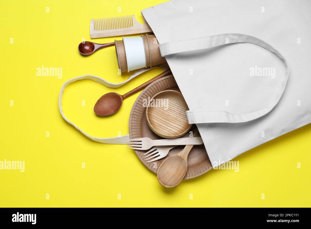 Eco bag with different disposable items on white background, top view ...