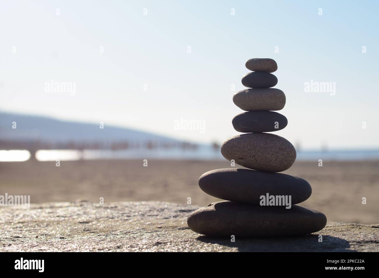 Stack of stones on parapet near sea, space for text Stock Photo - Alamy