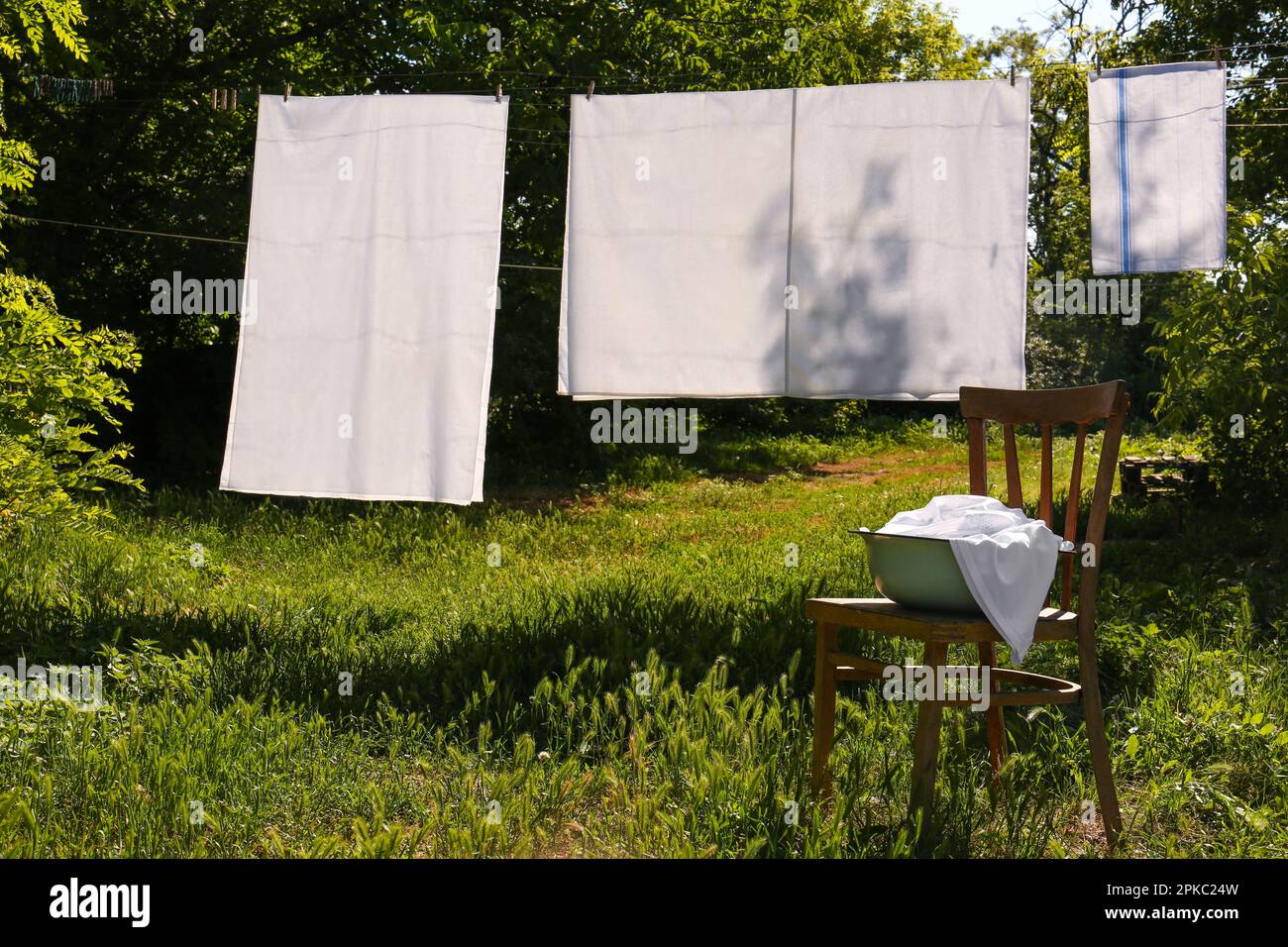 Washing line with clean laundry and clothespins outdoors Stock Photo ...