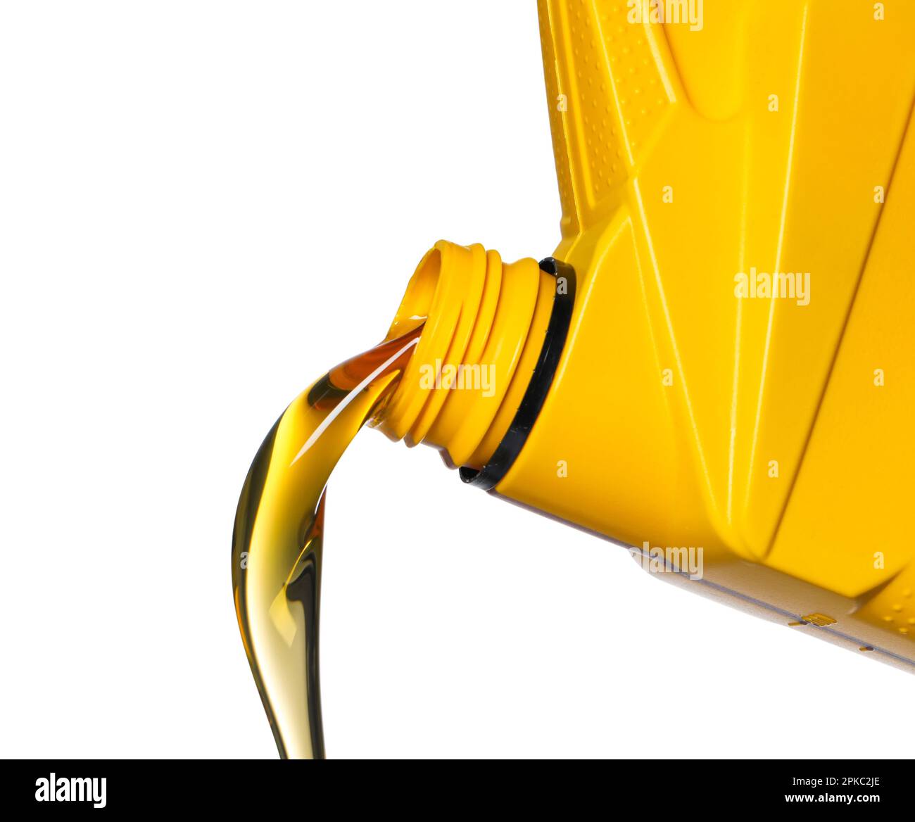 Pouring motor oil from yellow container on white background, closeup ...