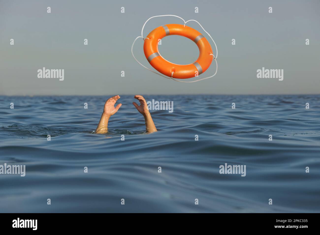 Lifebuoy drowning man in sea hi-res stock photography and images - Alamy