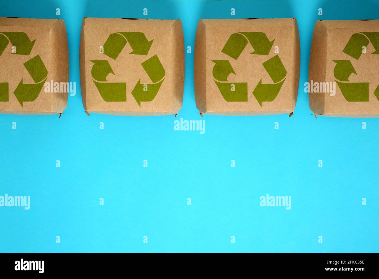 Paper boxes with recycling symbols on turquoise background, flat lay ...
