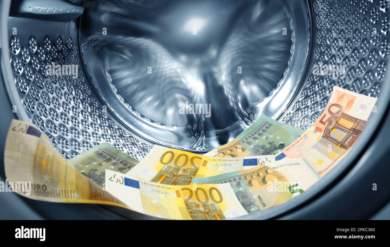 Money laundering. Many euro banknotes in washing machine Stock Photo ...