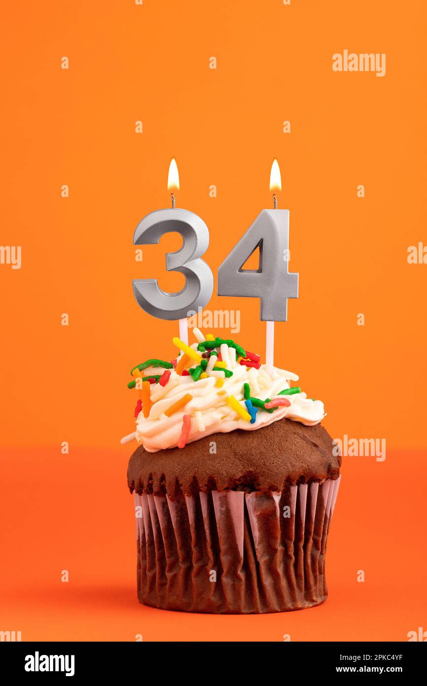 Birthday cake with candle number 34 - Orange foamy background Stock ...