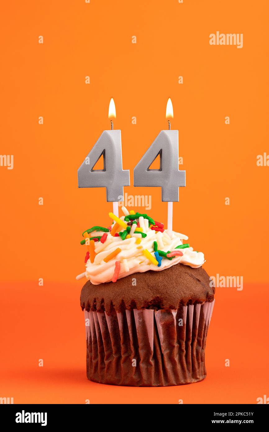 Birthday cake with candle number 44 - Orange foamy background Stock ...