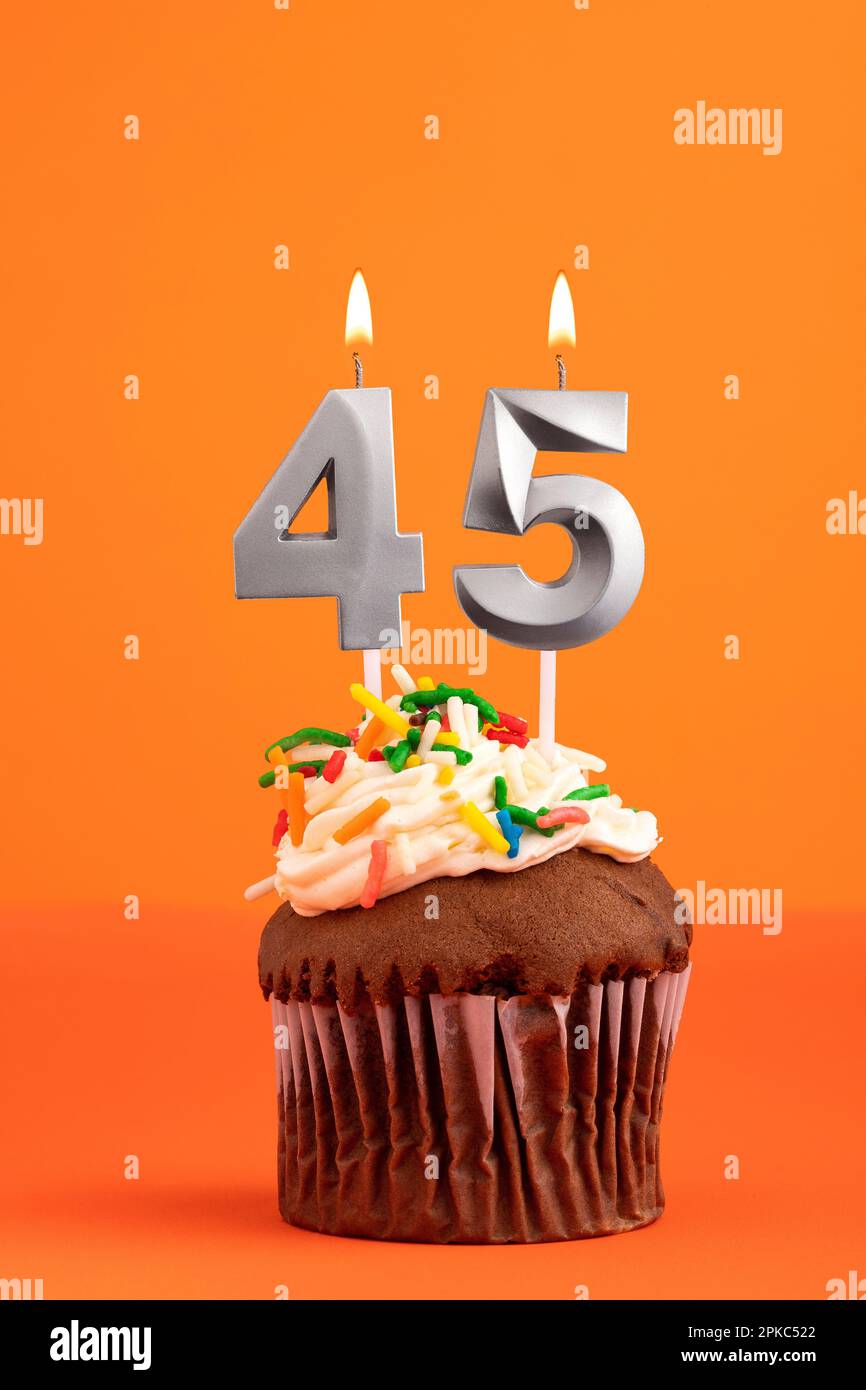 Candle number 45 - Cake birthday in orange background Stock Photo - Alamy
